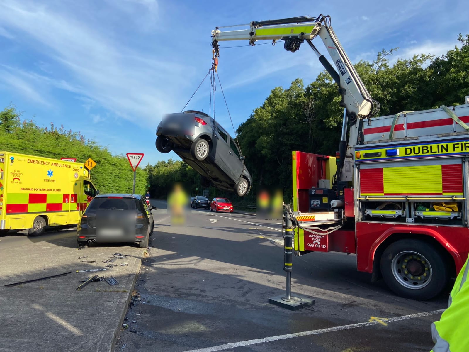 Firefighters use emergency crane to lift immobilised car from crash ...